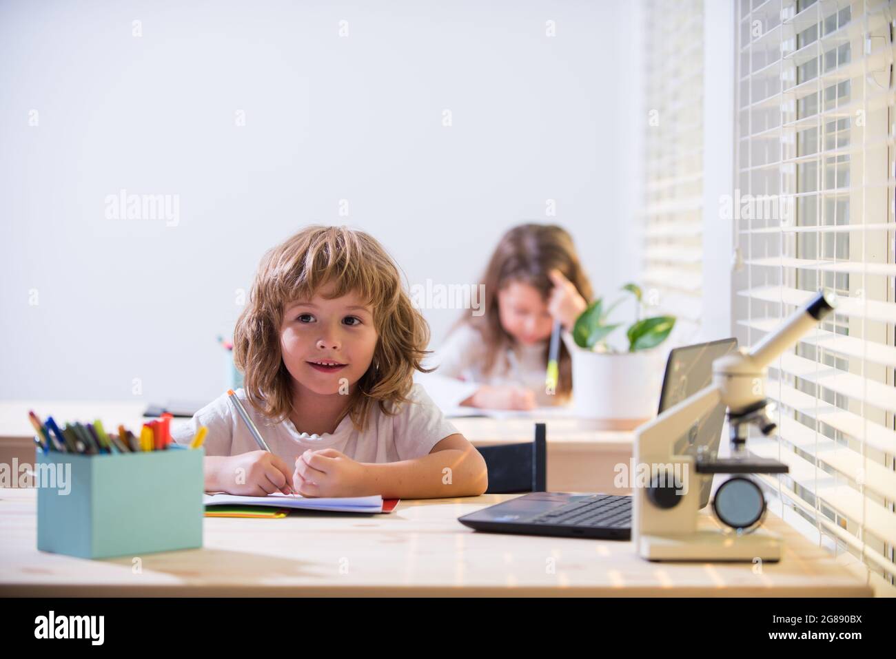 Schoolkids pupils studying homework math during lesson at classroom ...