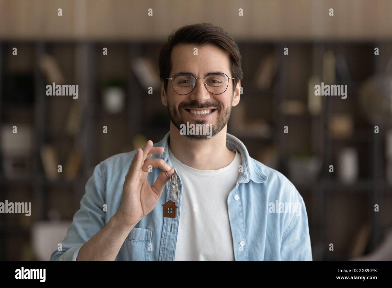 Happy young confident man holding keys in hands Stock Photo - Alamy