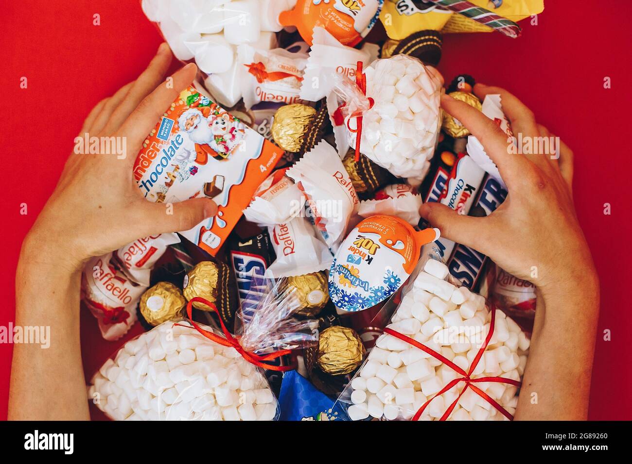 Lviv, Ukraine - December 1, 2017: Hands holding many sweets and candy ...