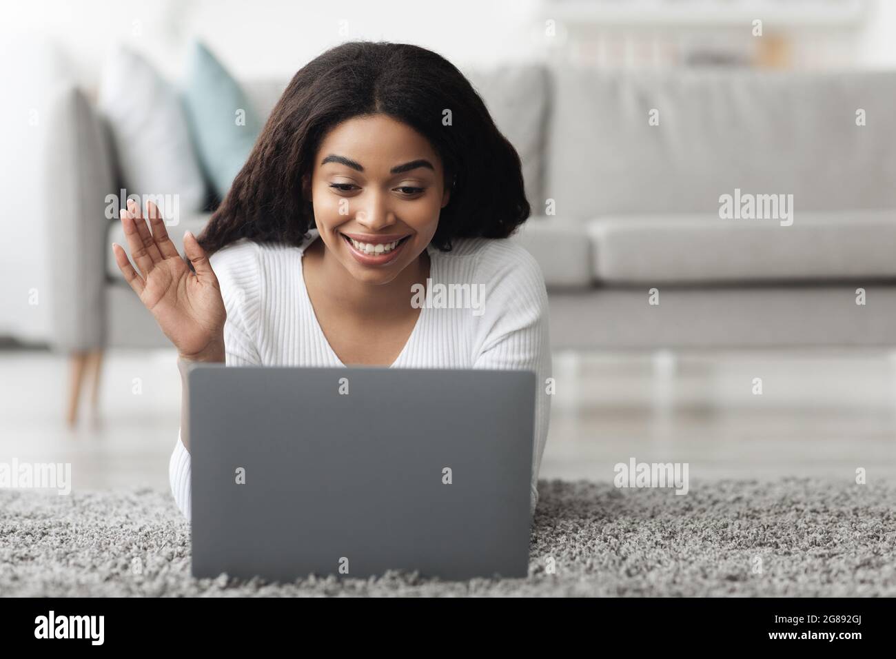 Online chat. Smiling african american lady with laptop making video ...