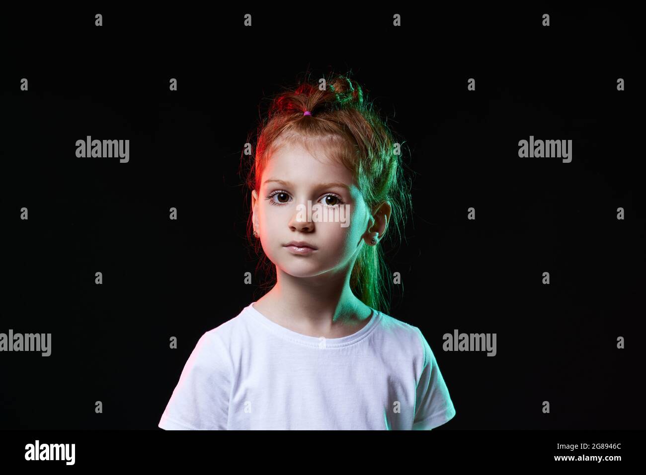 cute redhead little child girl on black background Stock Photo - Alamy