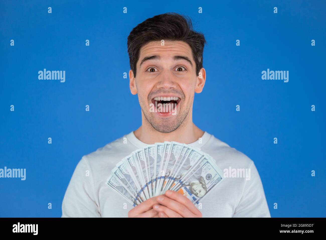 Happy excited man with cash money - USD currency dollars banknotes on ...