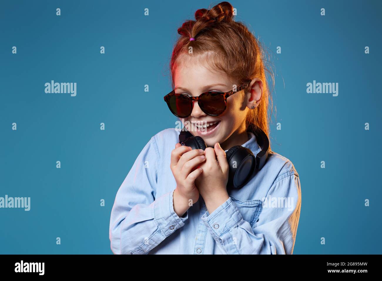 redhead child girl in sunglasses and wireless headphones Stock Photo ...