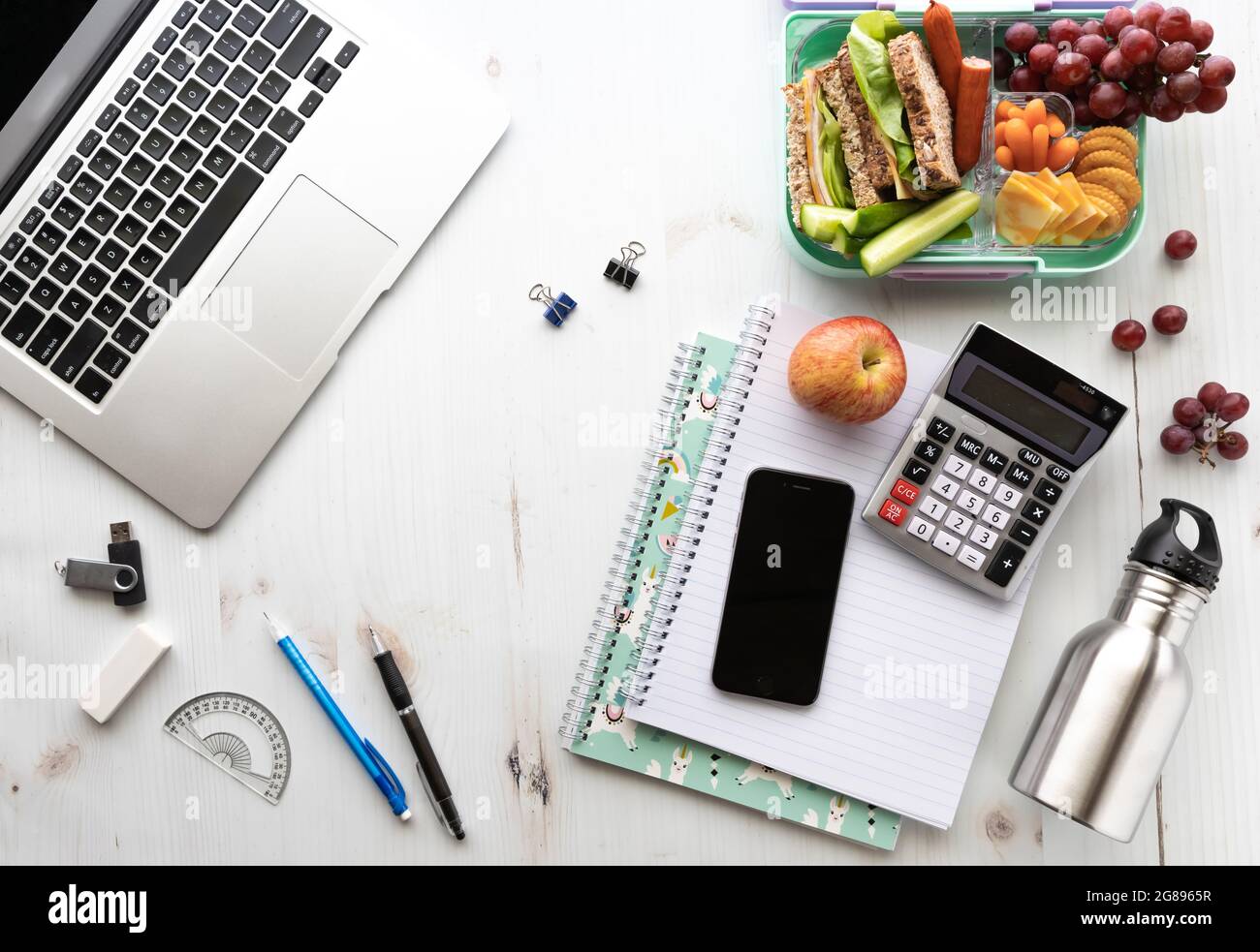 Top down view of a desktop arrangement of a laptop, cell phone and ...