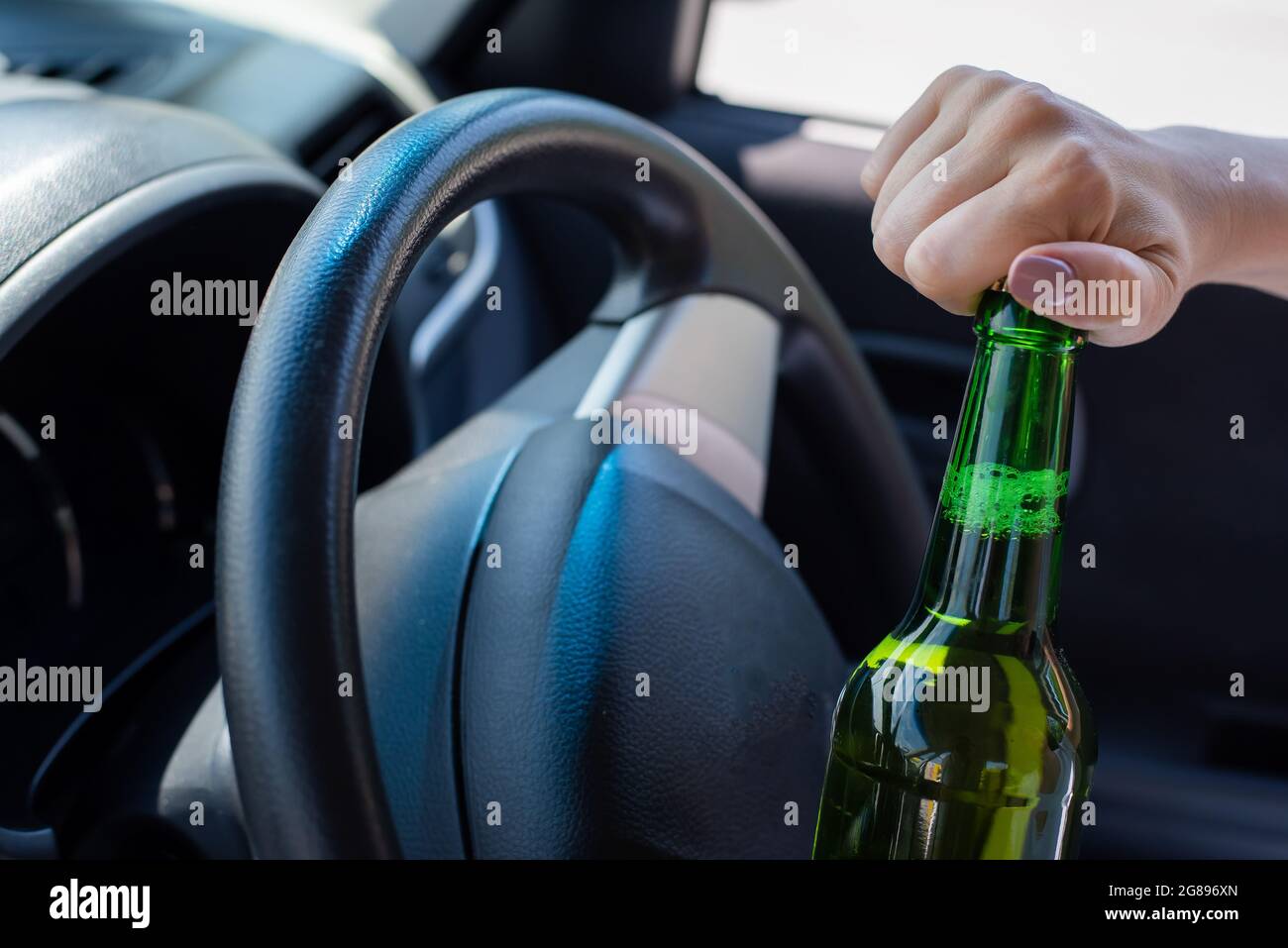 Hand holding beer bottle driving hi-res stock photography and images ...