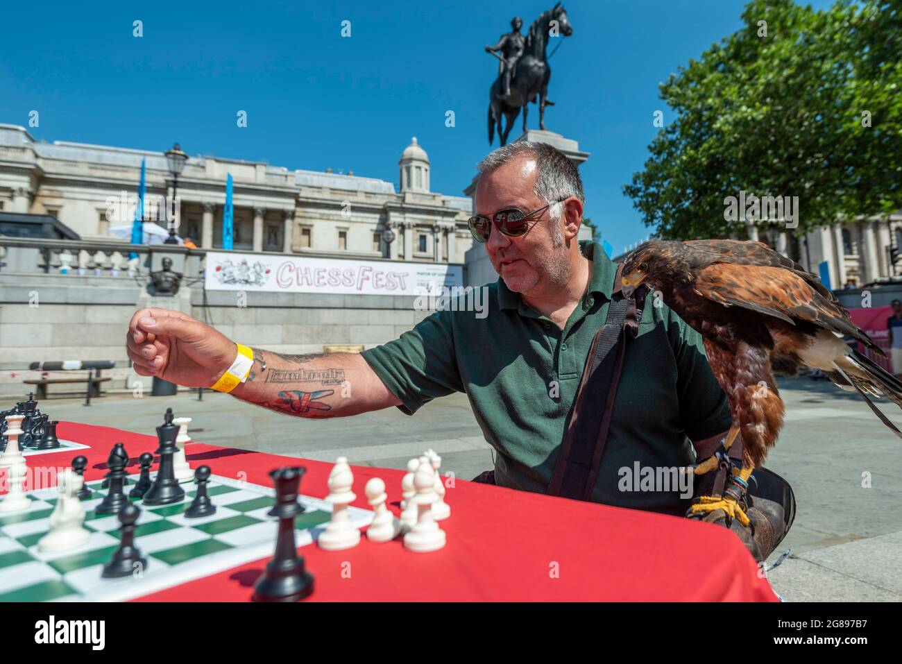 London, UK. 18 July 2021. Neve the Harris Hawk looks on as its handler ...