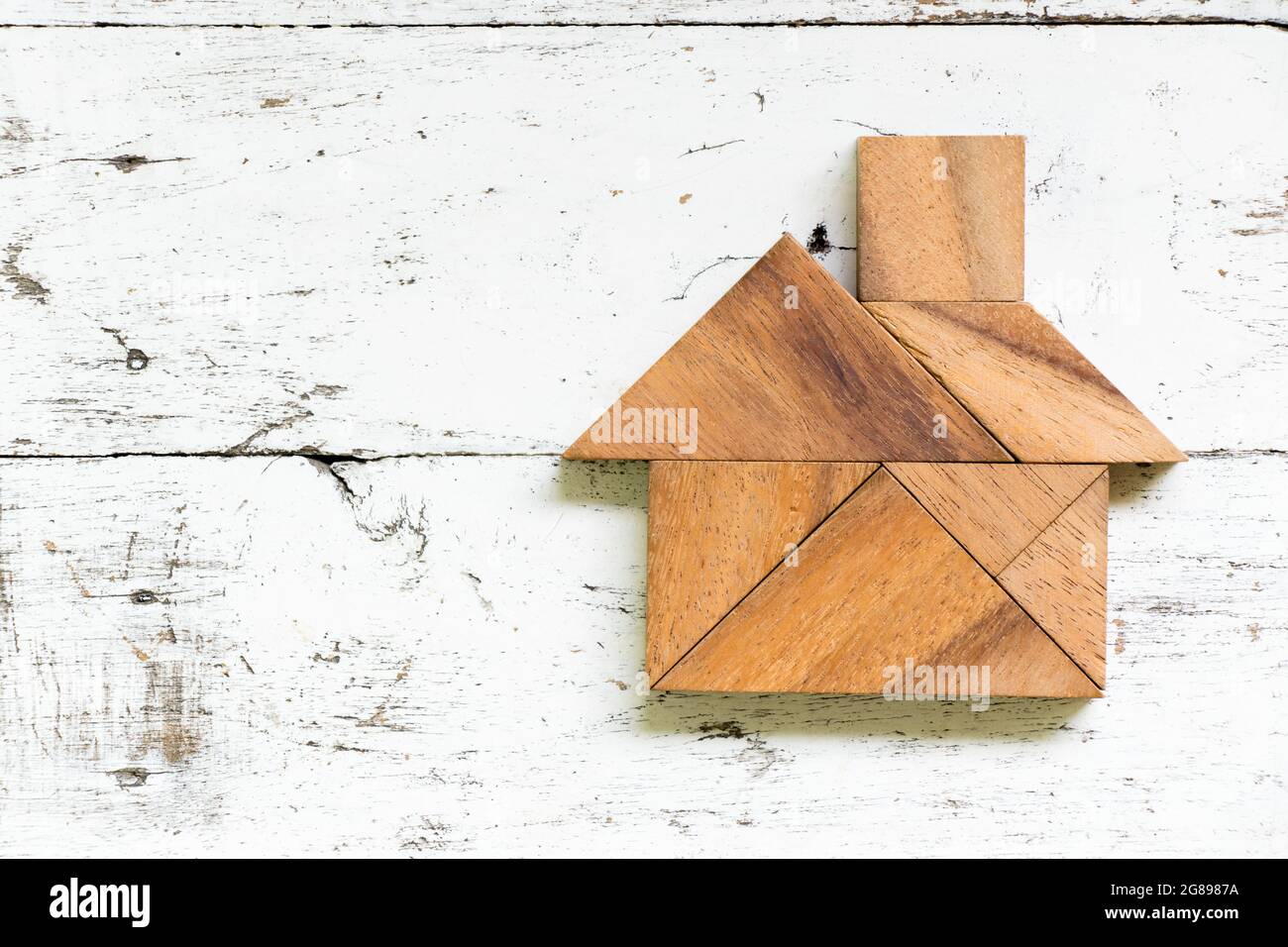Tangram puzzle in home shape on old white wood background Stock Photo ...