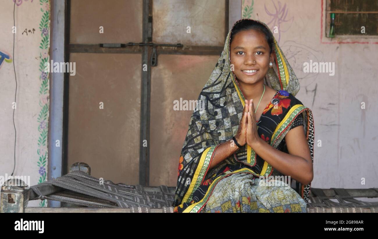A young Indian female in traditional clothes praying Stock Photo - Alamy