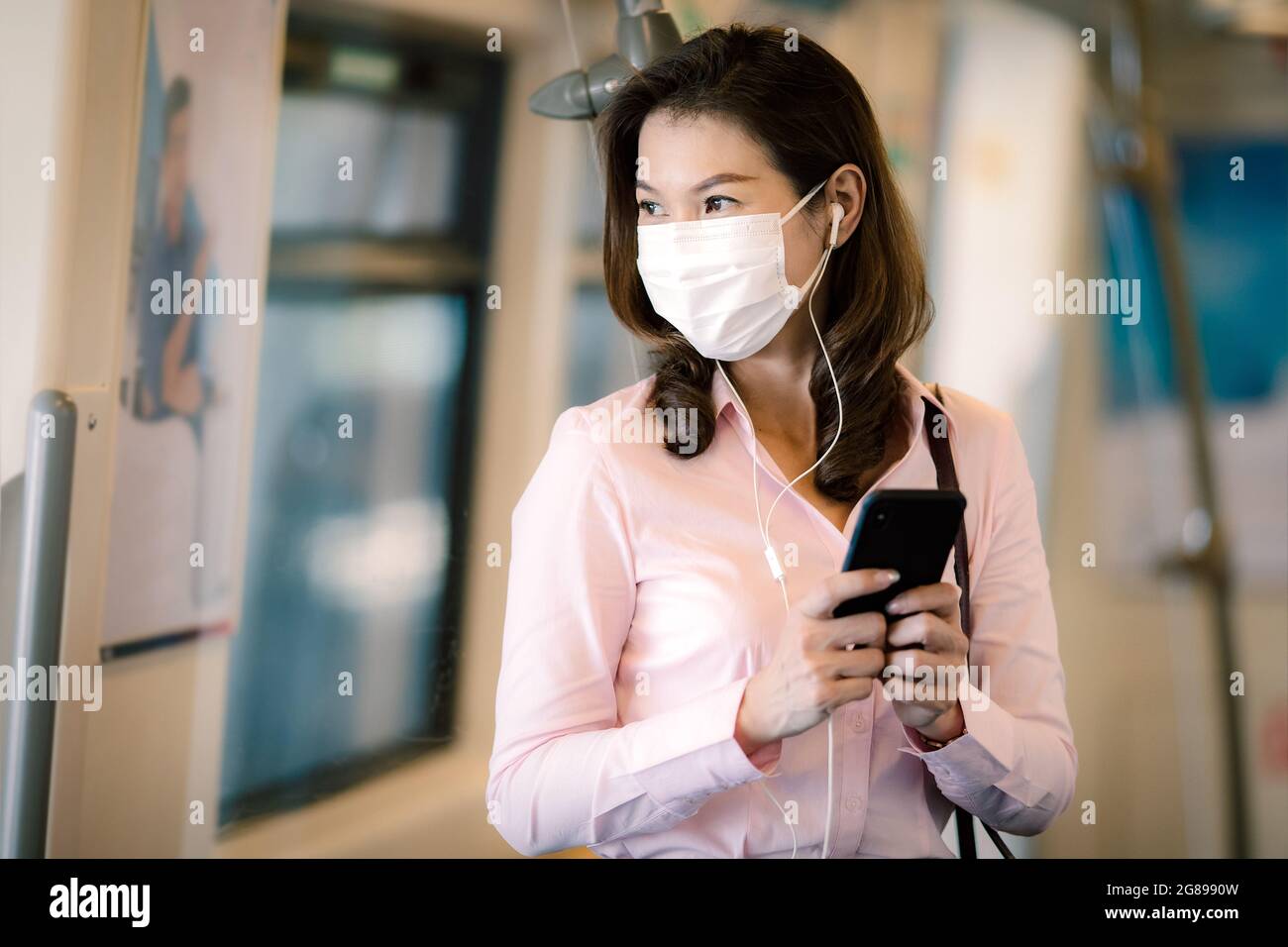 Beautiful cute smiley Asian businesswoman wearing protective surgical ...