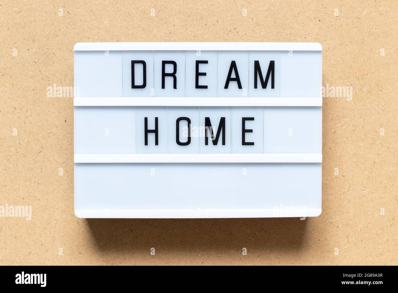 White lightbox with word dream home on wood background Stock Photo - Alamy
