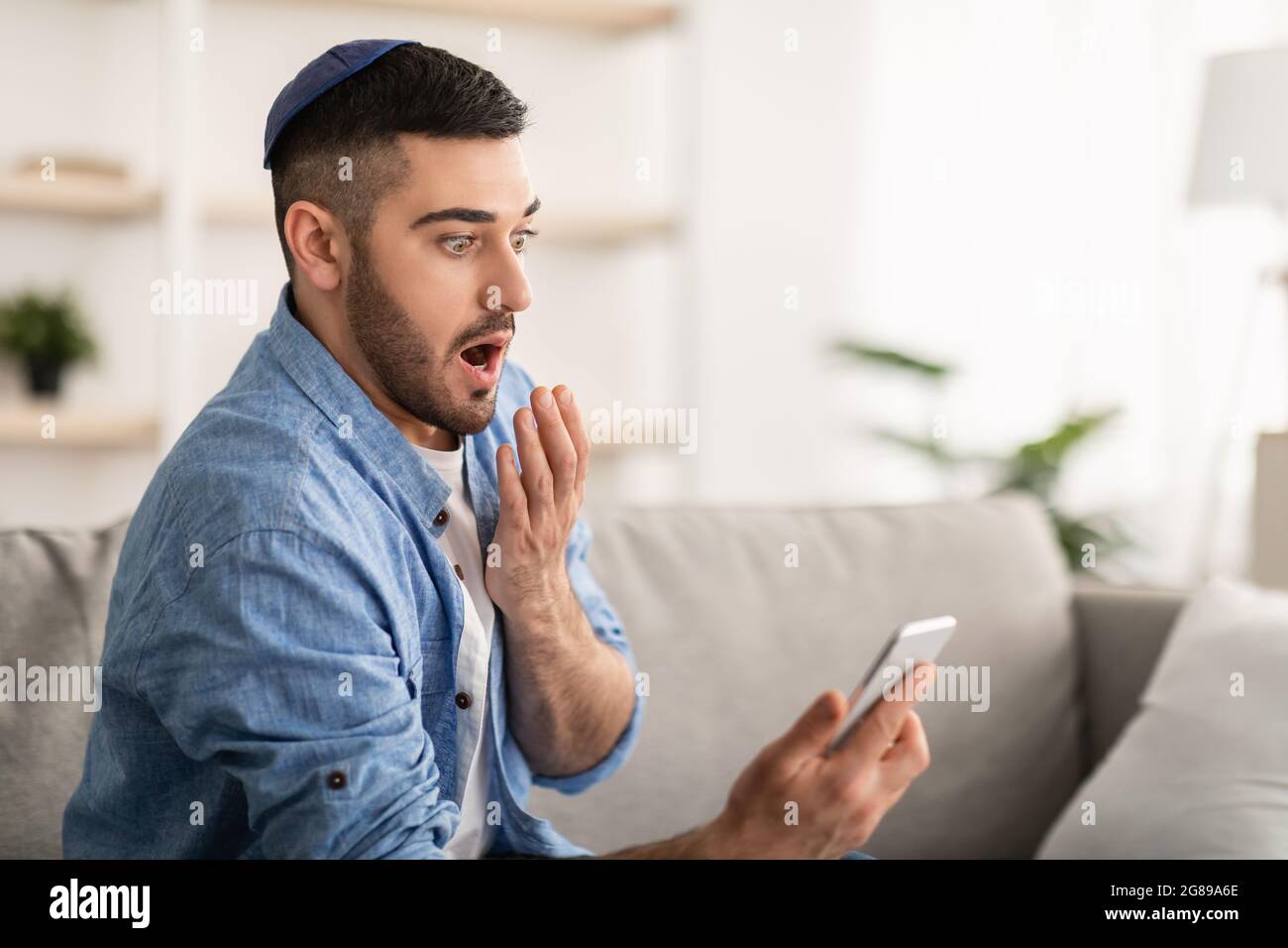 Shocked israeli man using his mobile phone Stock Photo - Alamy