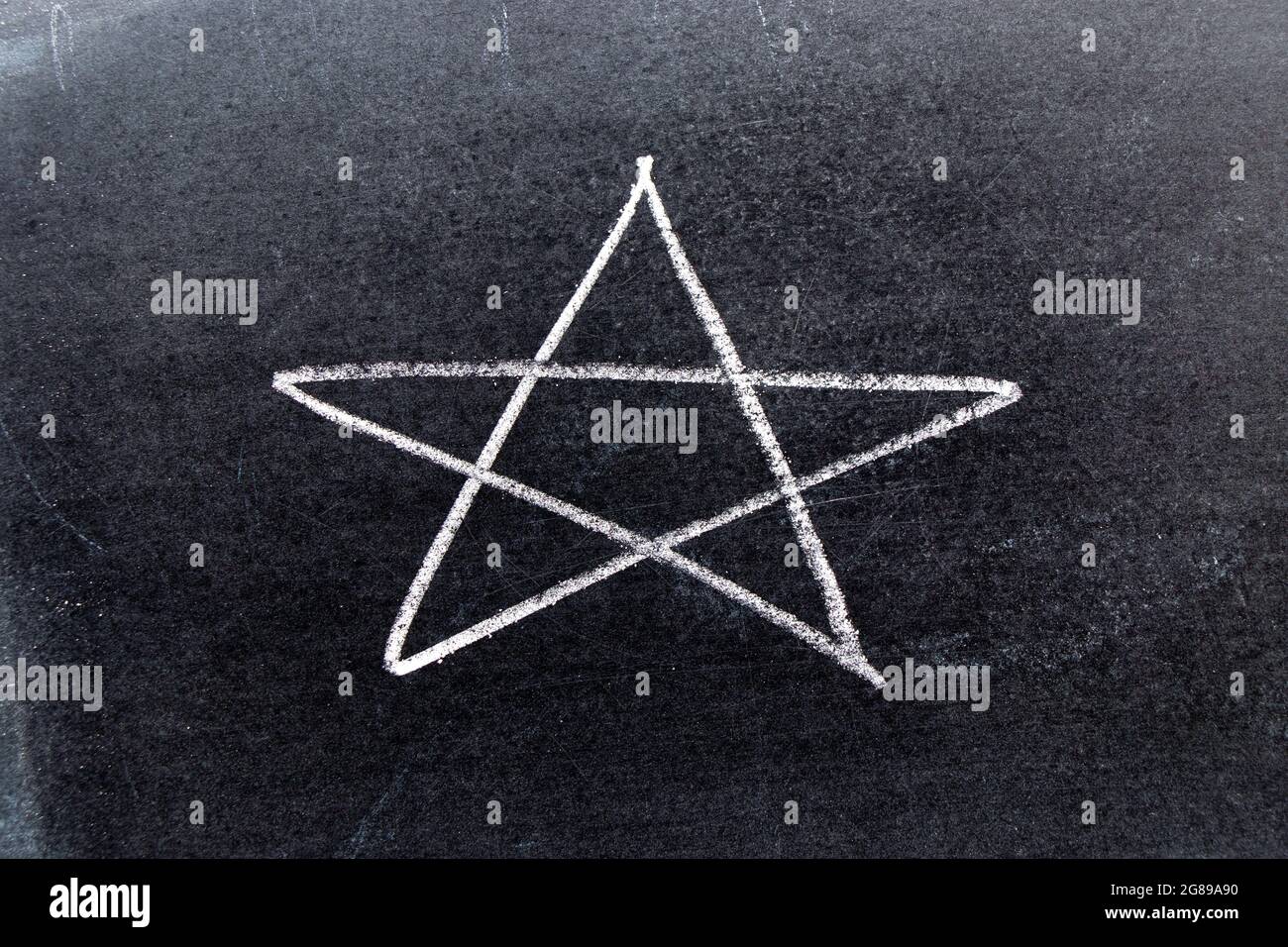 White chalk hand drawing in star shape on black board background Stock ...