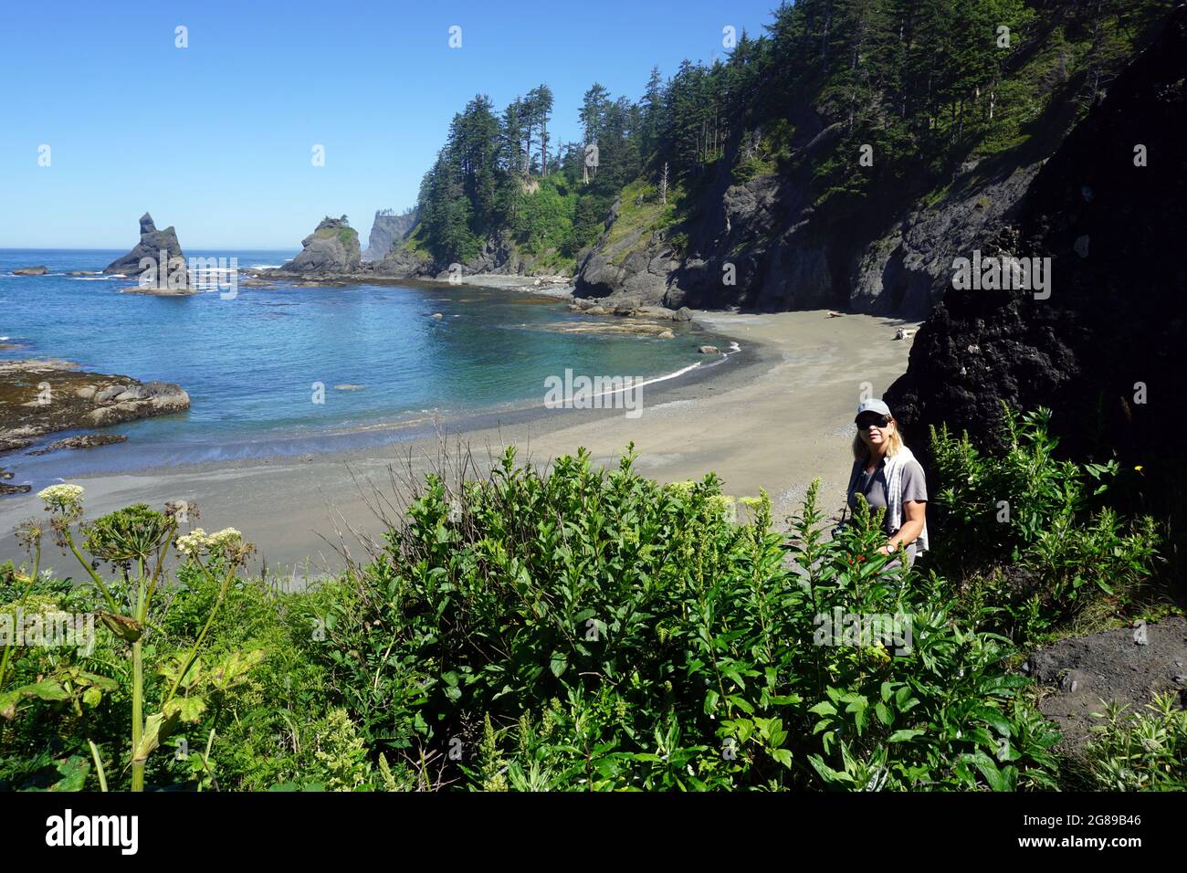 Hiker on secluded Shi Shi Beach on Pacific shore near Neah Bay ...