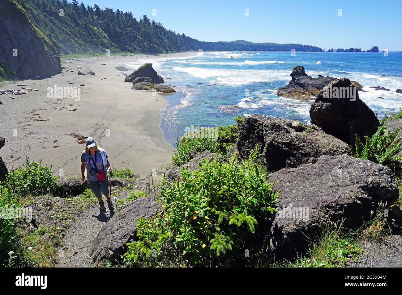 Hiker on secluded Shi Shi Beach on Pacific shore near Neah Bay ...