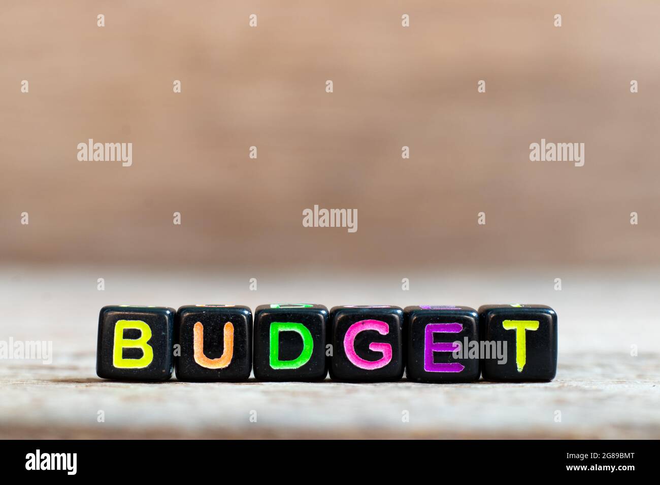 Black bead with color alphabet in word budget on wood background Stock ...
