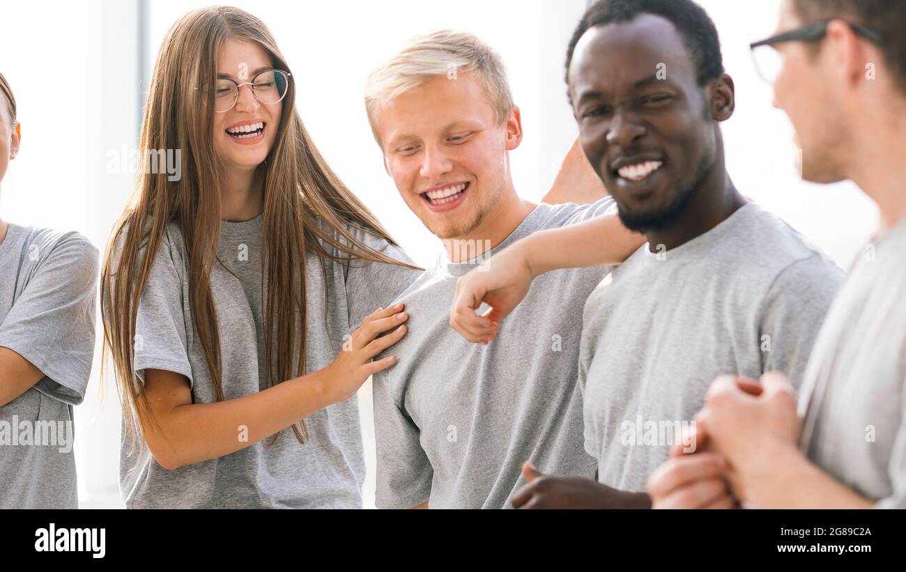 group of happy young people standing in a bright room Stock Photo - Alamy