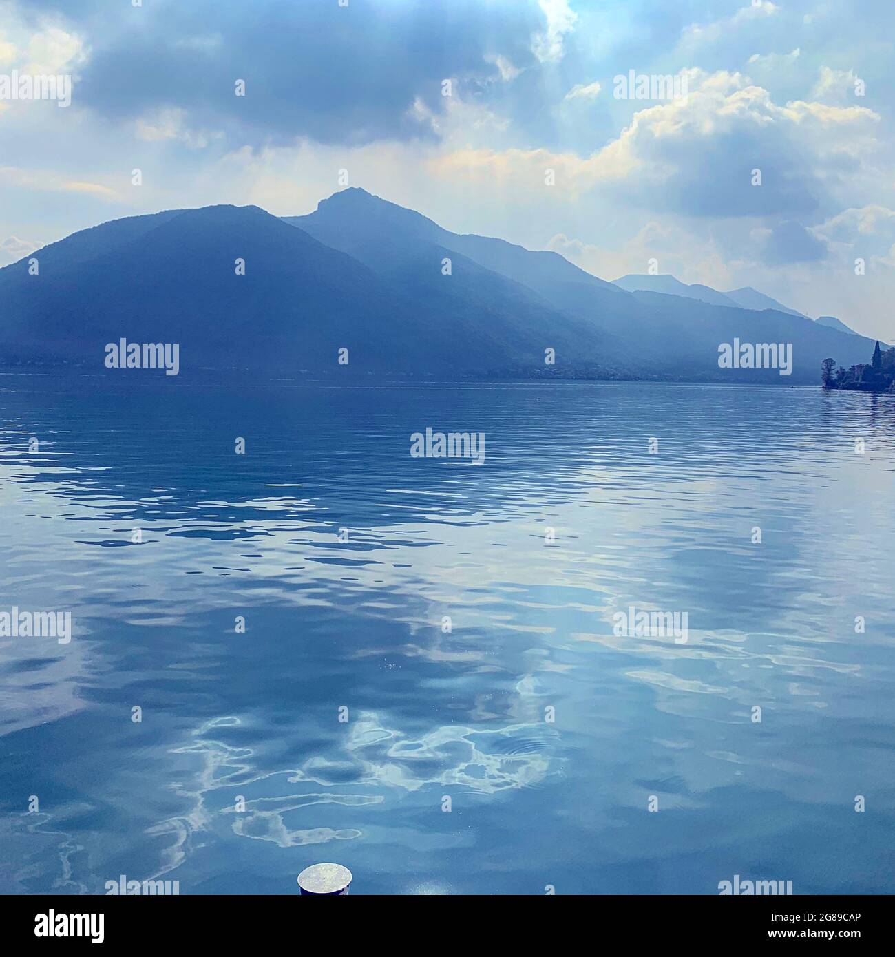 A scenic view of the calm lake with reflection of the sky on the ...