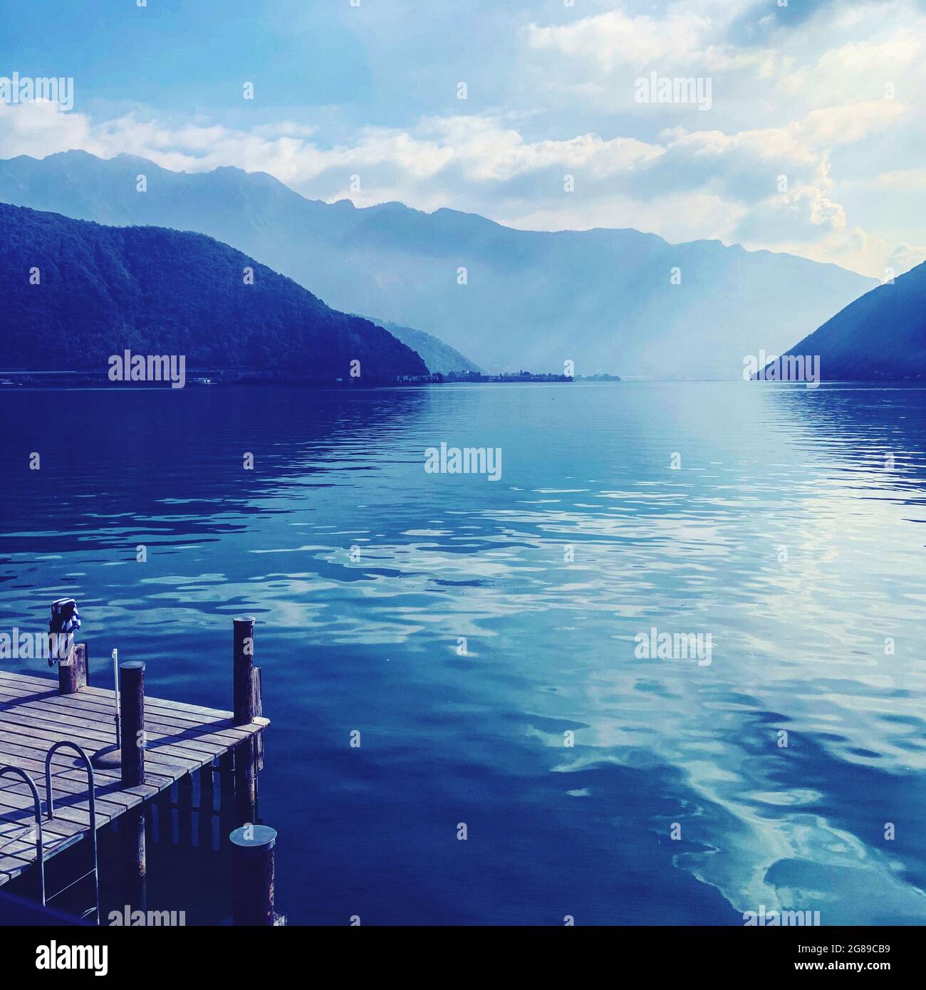 A scenic view of the calm lake with reflection of the sky on the ...