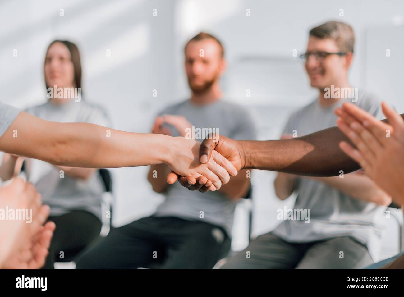 close up. strong handshake of partners during the international Stock ...