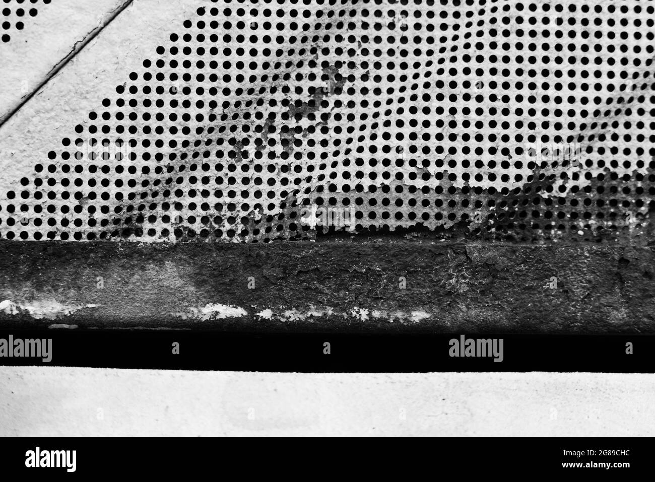 Perforated, painted and dirty sheet metal, the background of an ...