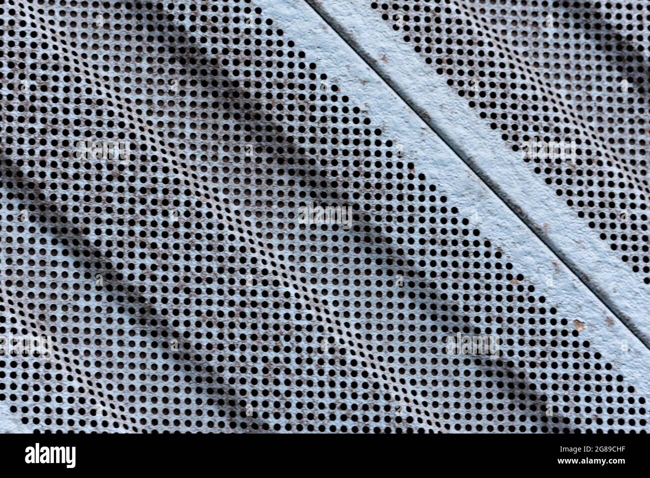 Perforated, painted and dirty sheet metal, the background of an ...