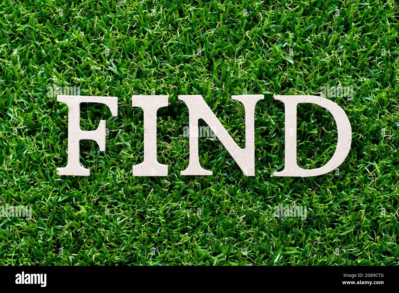Wood letter in word find on artificial green grass background Stock ...