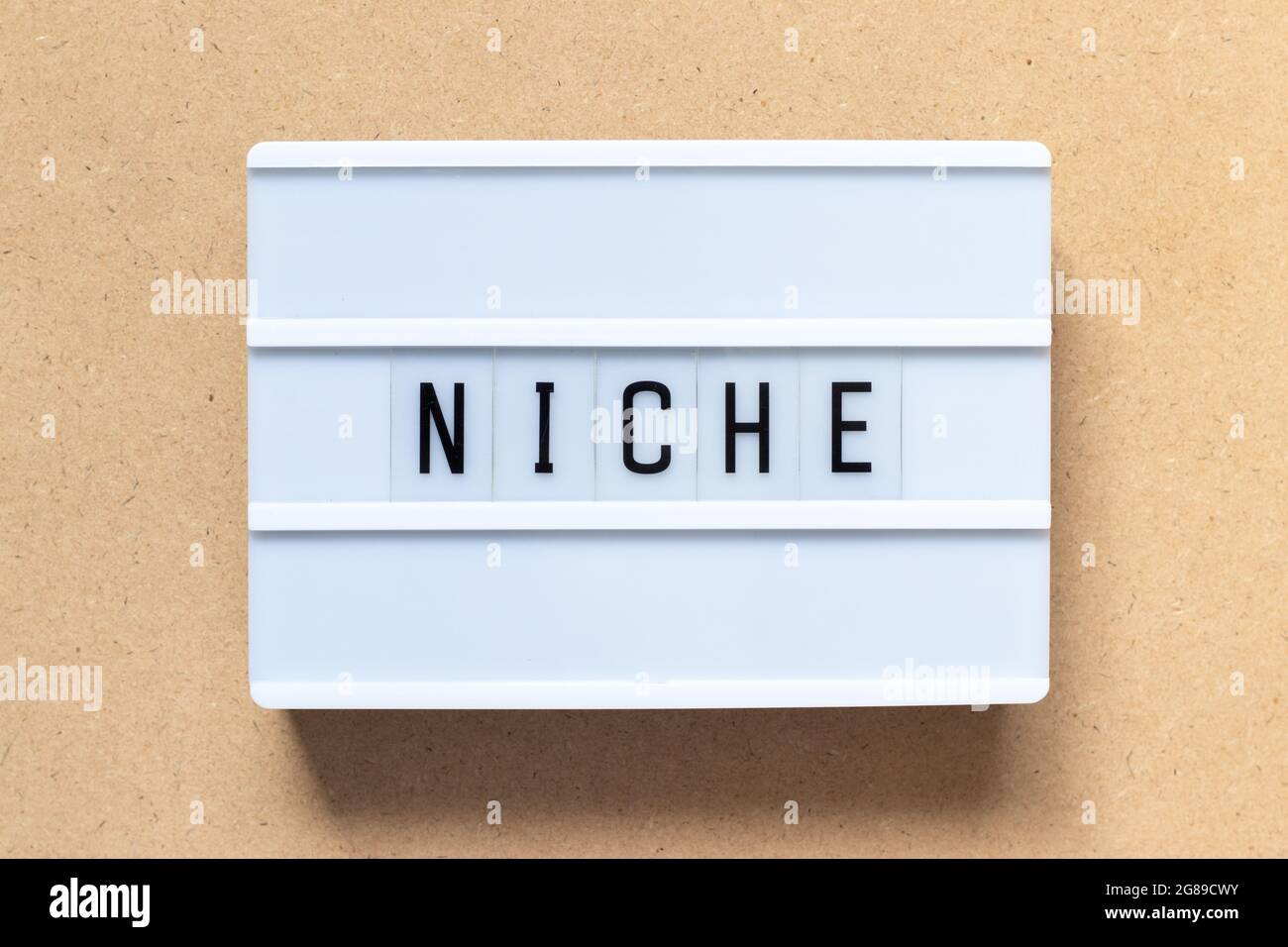 White lightbox with word niche on wood background Stock Photo - Alamy