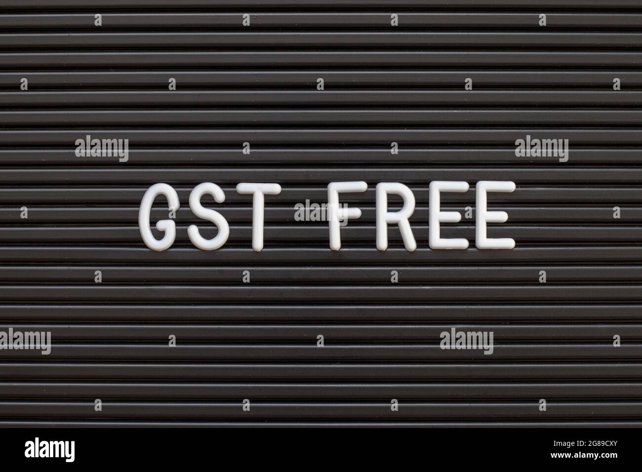 Black color felt letter board with white alphabet in word GST ...