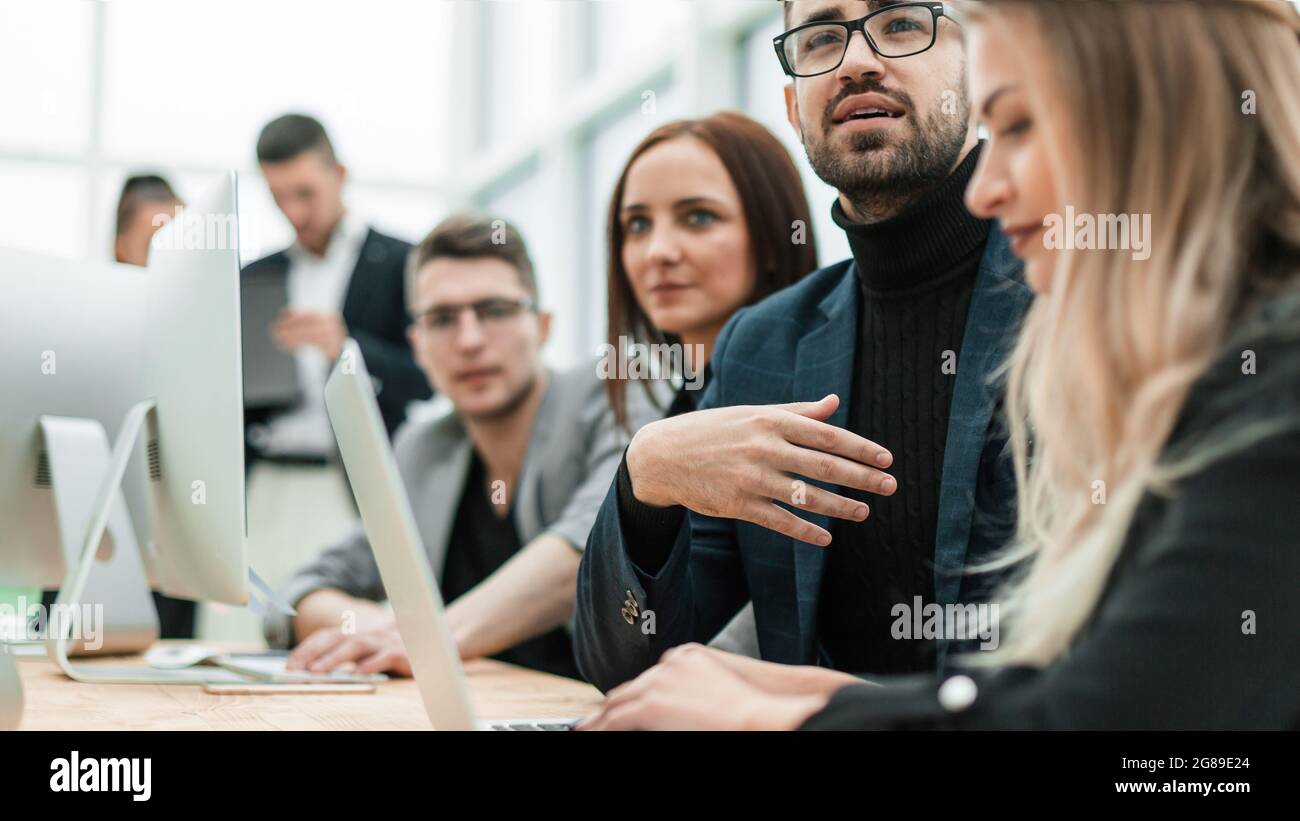 close up. employees work on laptops in a modern office Stock Photo - Alamy