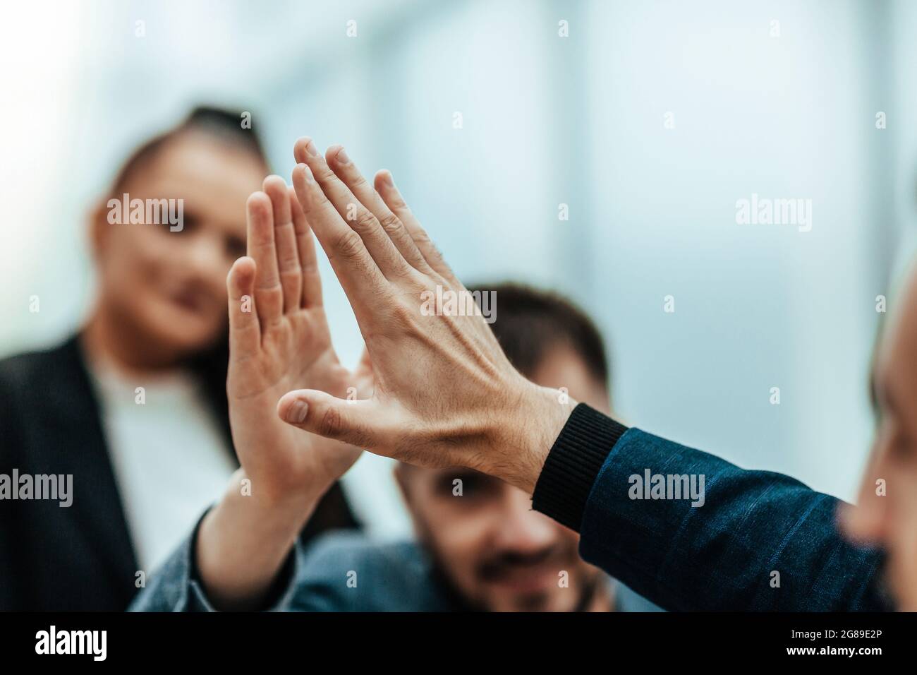 close up. young employees giving each other a high five Stock Photo - Alamy