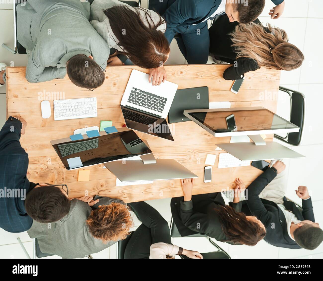 top view. business team sitting at Desk and looking at blank screen ...