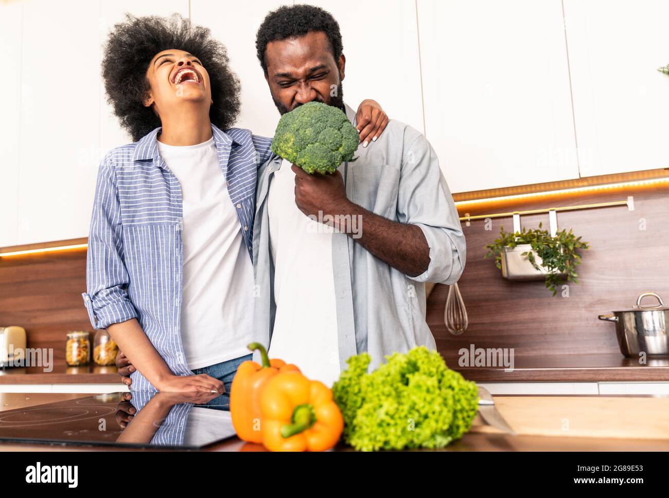 Beautiful afro american couple cooking at home - Beautiful and cheerful ...
