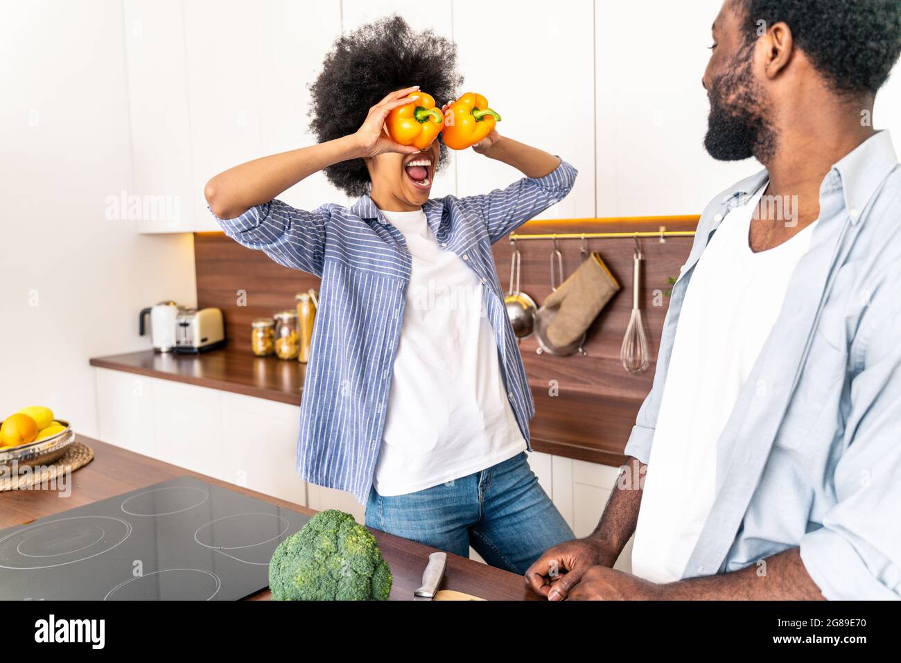 Beautiful afro american couple cooking at home - Beautiful and cheerful ...