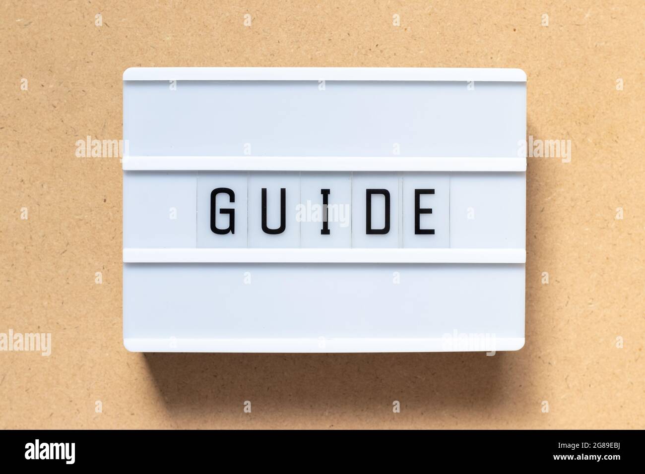 White lightbox with word guide on wood background Stock Photo - Alamy