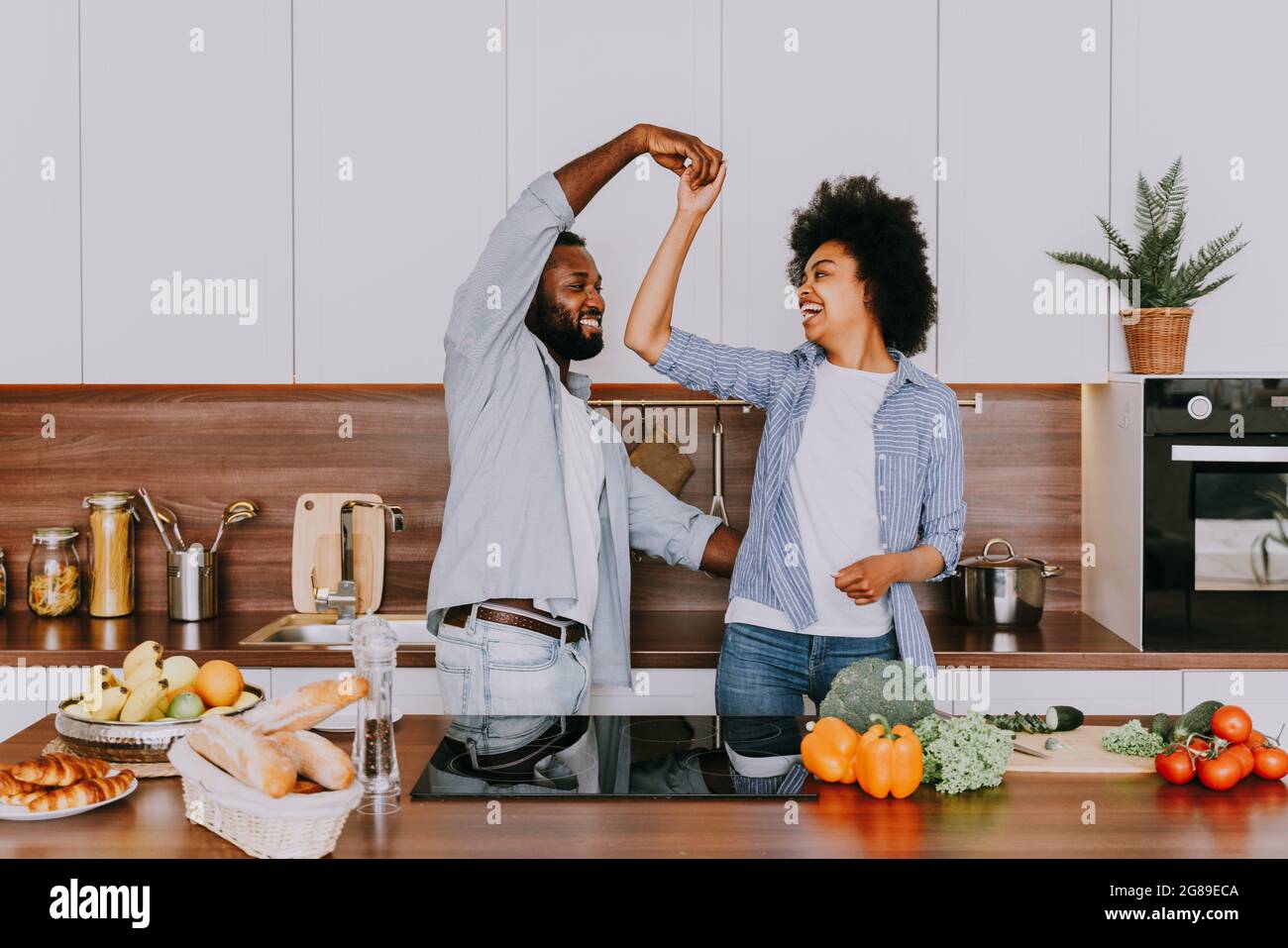 Beautiful afro american couple cooking at home - Beautiful and cheerful ...