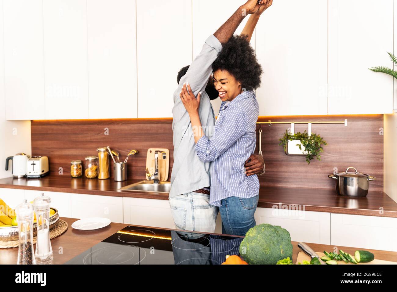 Beautiful afro american couple cooking at home - Beautiful and cheerful ...
