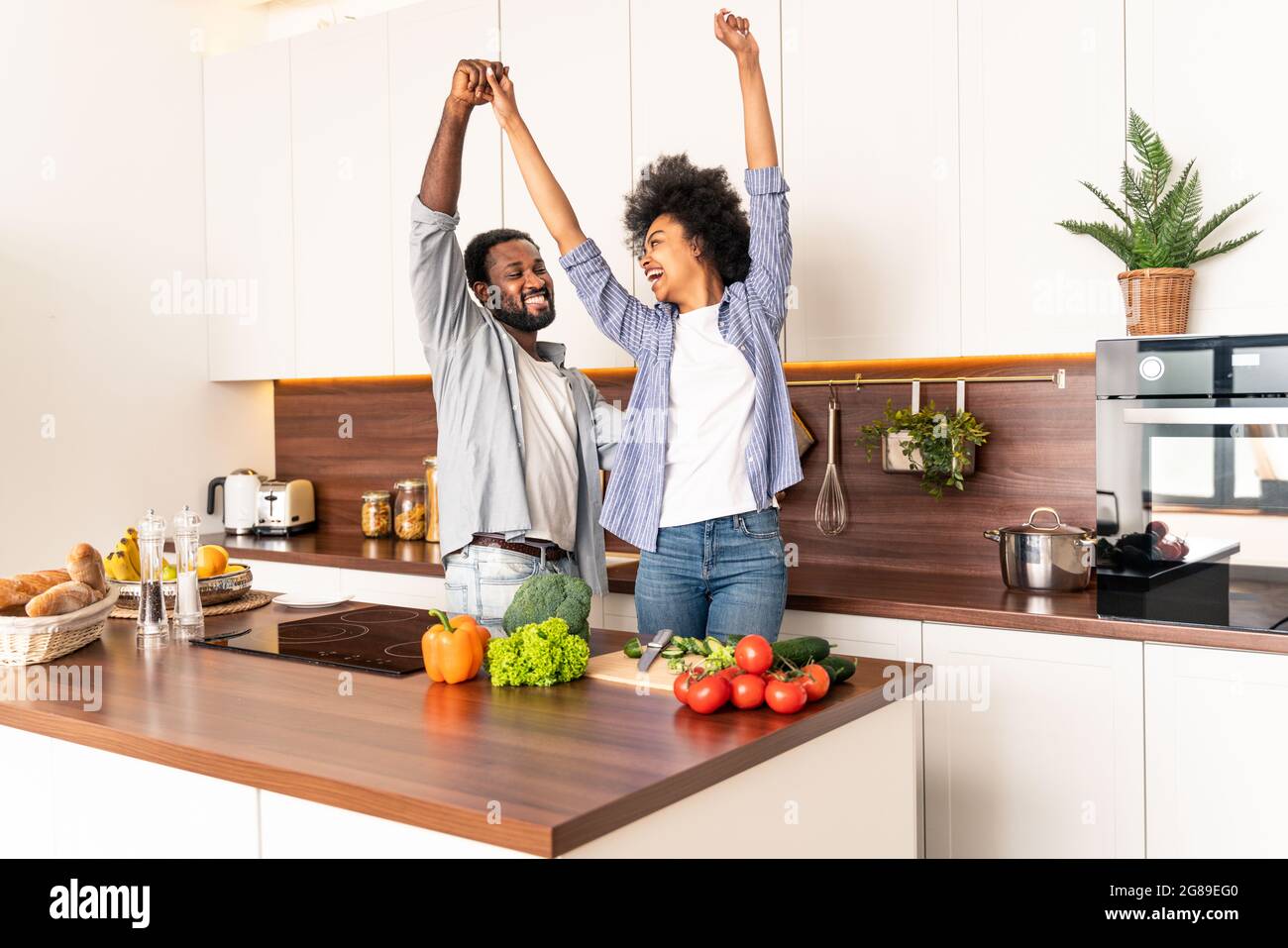 Beautiful afro american couple cooking at home - Beautiful and cheerful ...