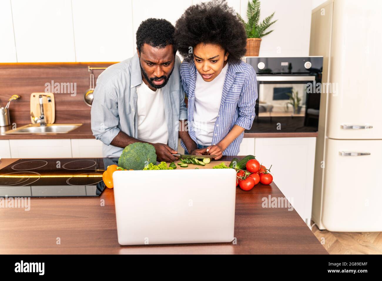 Beautiful afro american couple cooking at home - Beautiful and cheerful ...