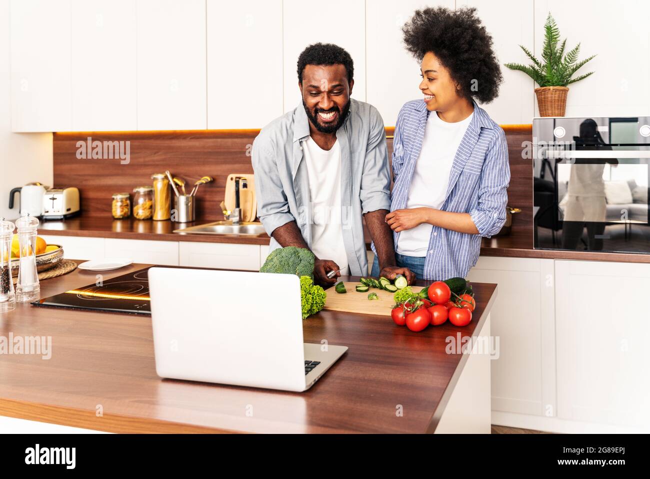 Beautiful afro american couple cooking at home - Beautiful and cheerful ...