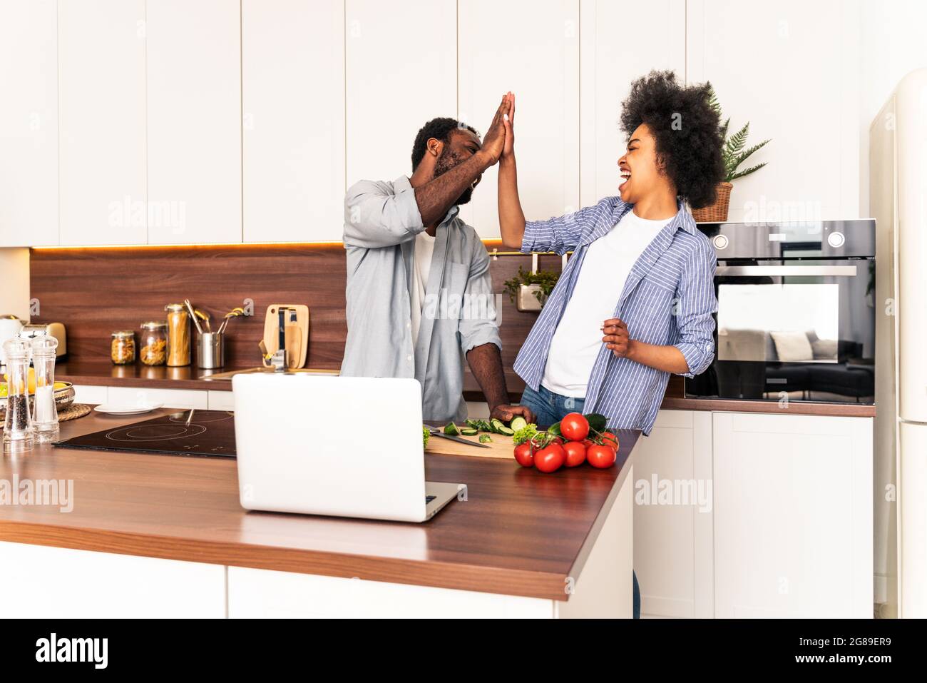 Beautiful afro american couple cooking at home - Beautiful and cheerful ...