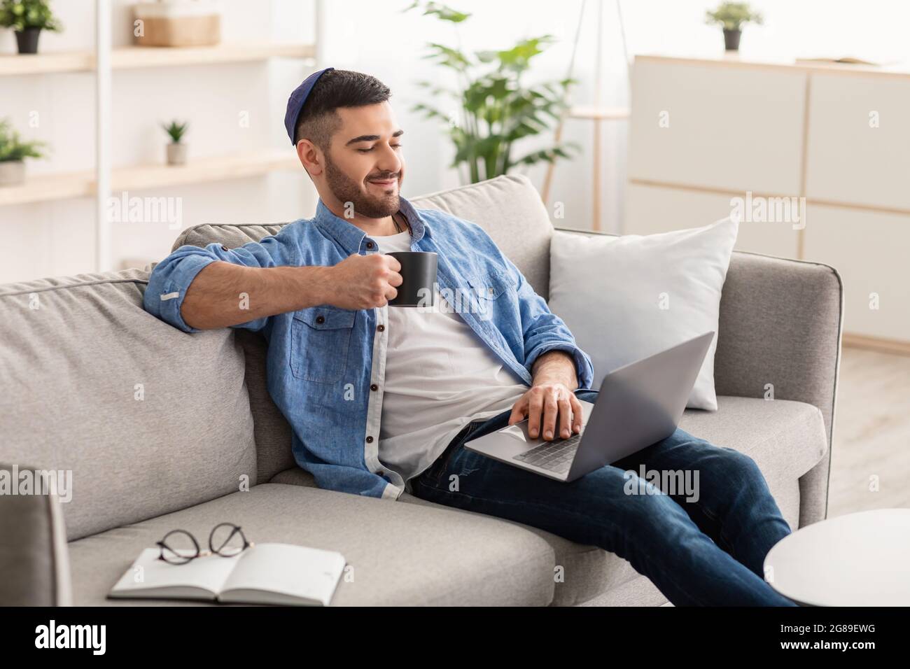 Jewish man working on computer, drinking coffee Stock Photo - Alamy