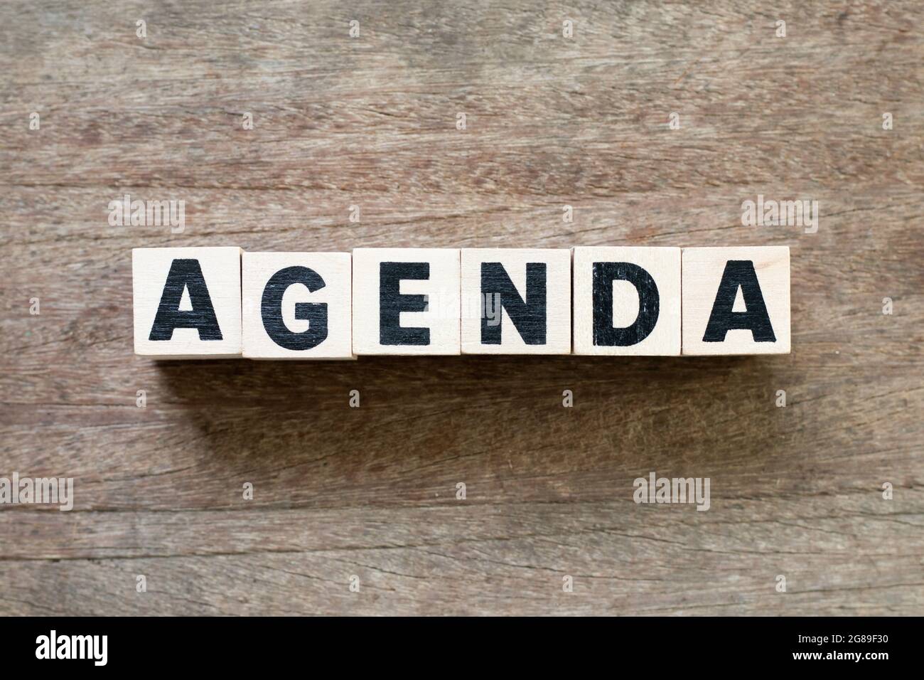 Letter block in word agenda on wood background Stock Photo - Alamy