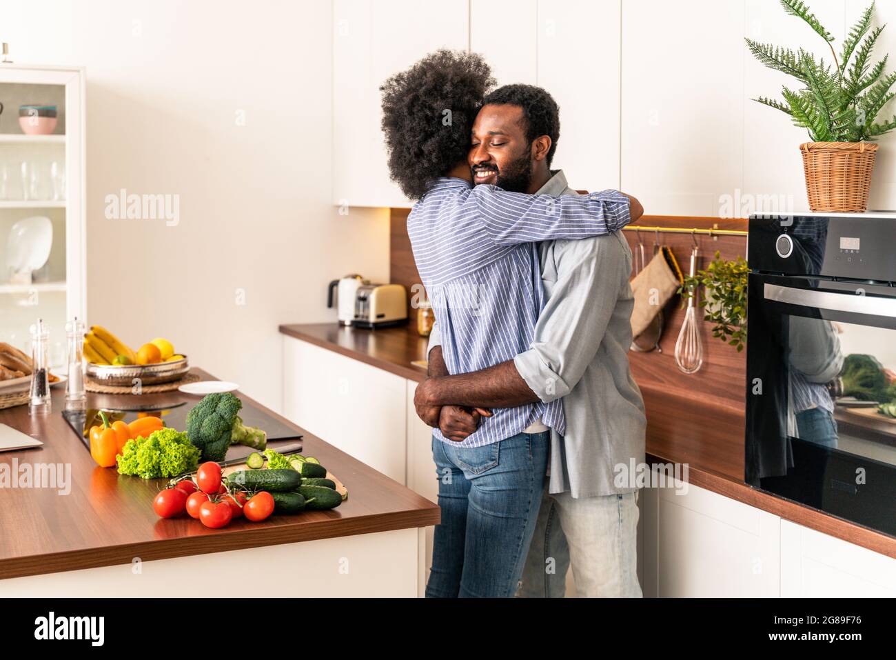 Beautiful afro american couple cooking at home - Beautiful and cheerful ...