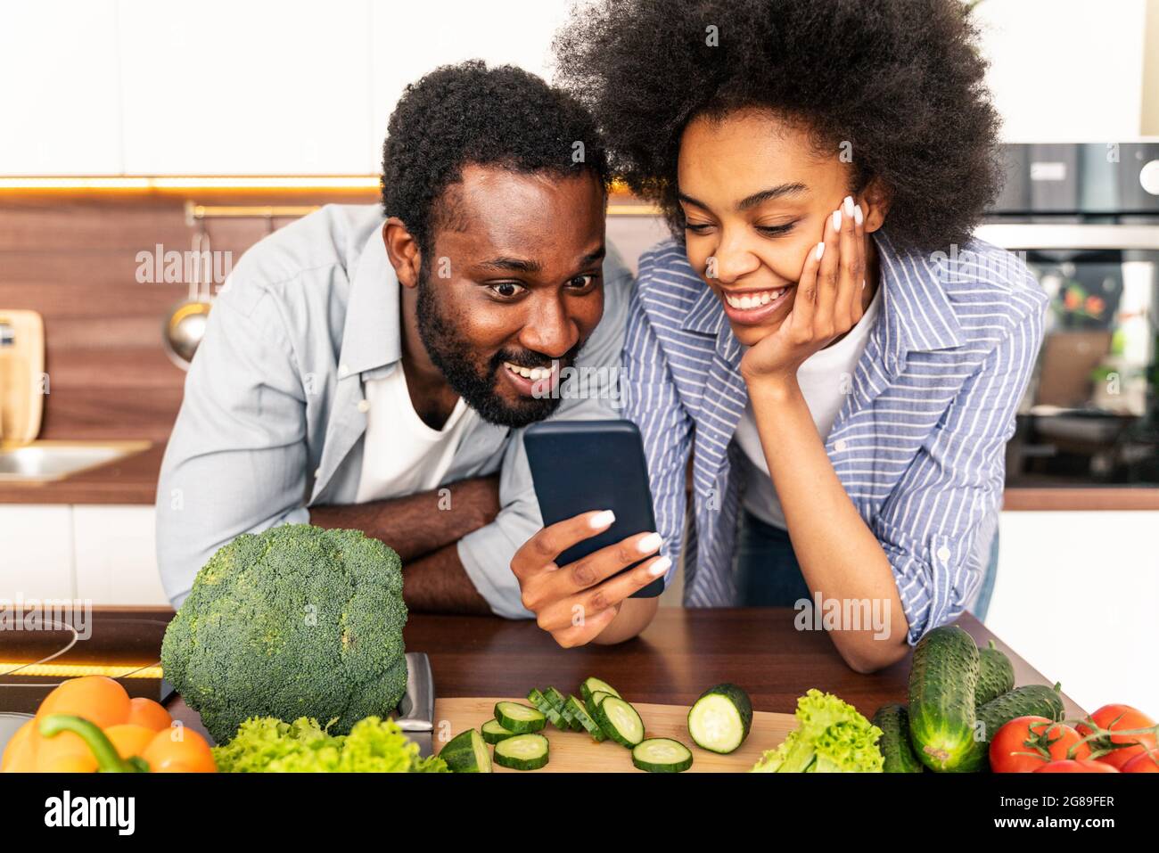Beautiful afro american couple cooking at home - Beautiful and cheerful ...
