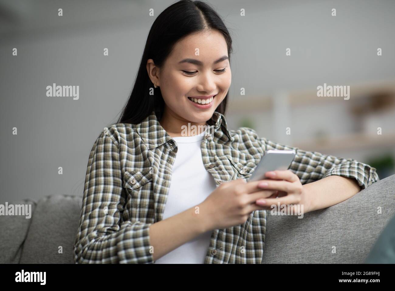 Positive korean woman using smartphone hi-res stock photography and ...