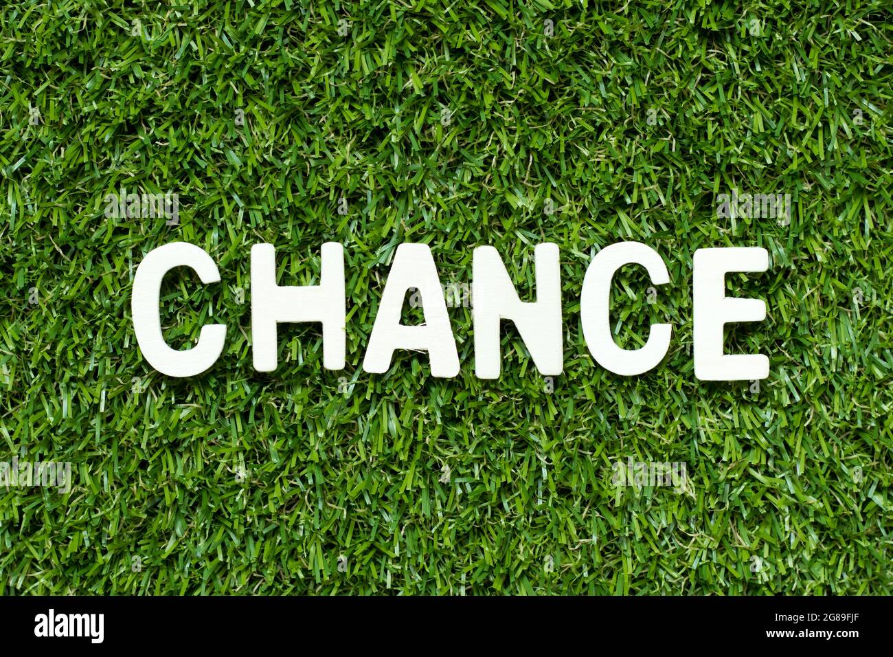 Alphabet letter in word chance on artificial green grass background ...