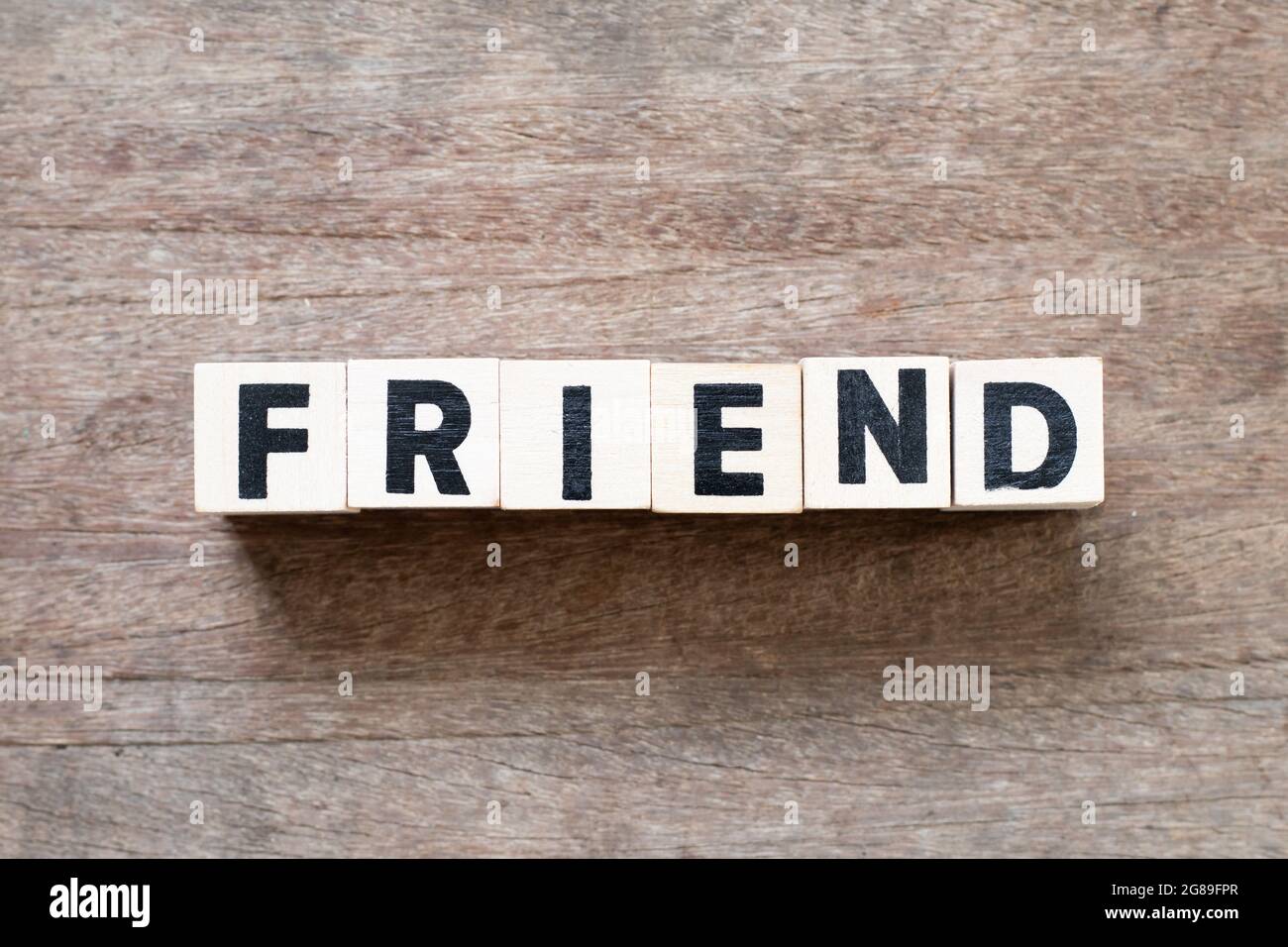 Letter block in word friend on wood background Stock Photo - Alamy