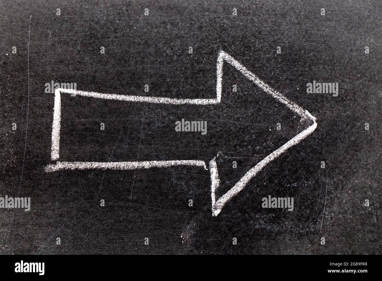 White chalk hand drawing in arrow shape on black board background Stock ...