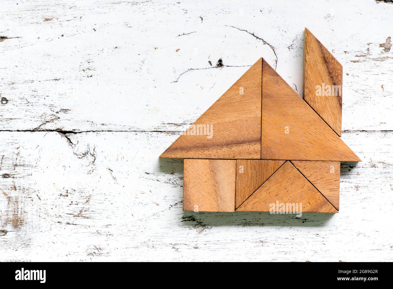 Tangram puzzle in home shape on old white wood background Stock Photo ...