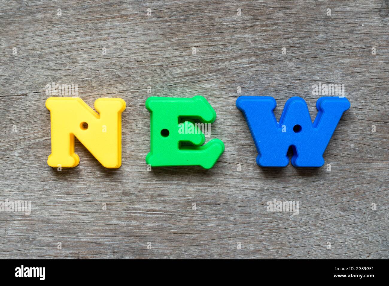 Colorful plastic alphabet in word new on wood background Stock Photo ...
